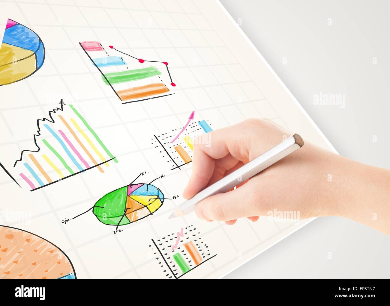 Business person drawing colorful graphs and icons on paper Stock Photo ...