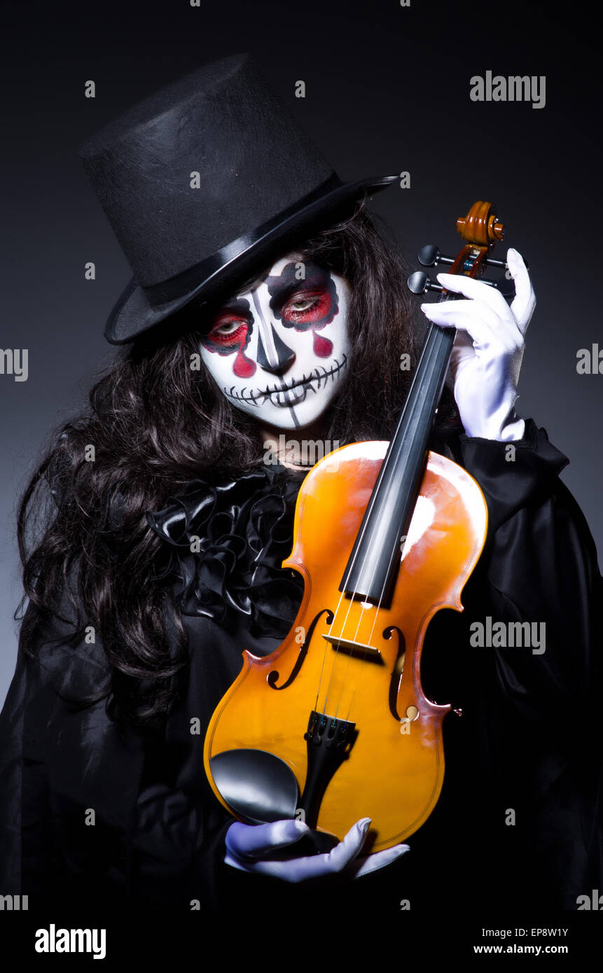 Monster playing violin in dark room Stock Photo - Alamy