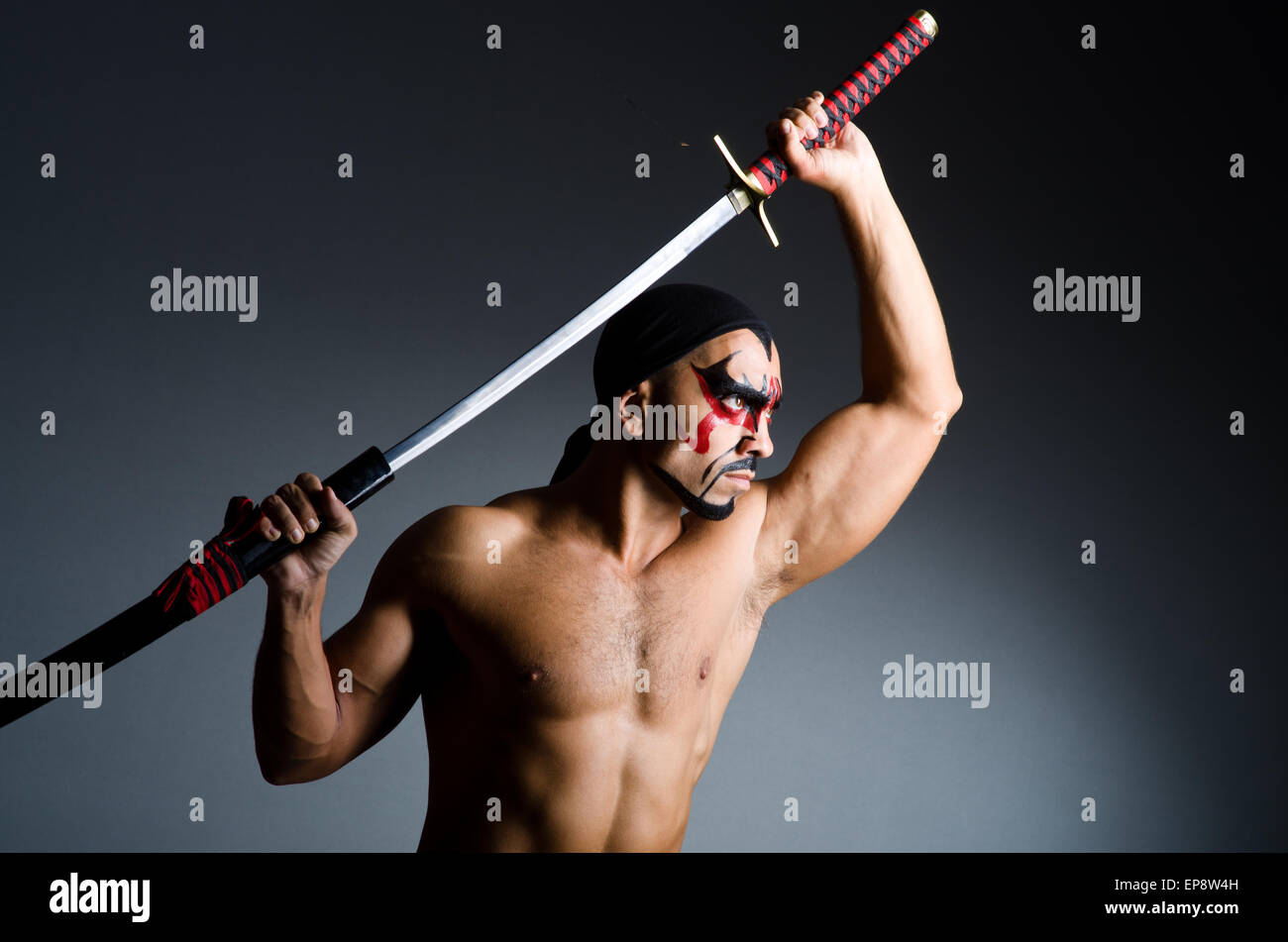 Man with sword and face paint Stock Photo - Alamy