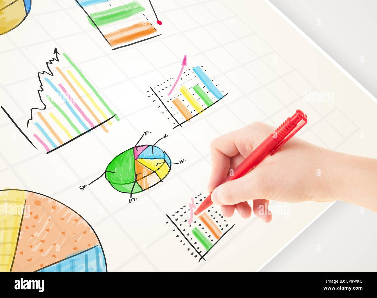 Business person drawing colorful graphs and icons on paper Stock Photo ...