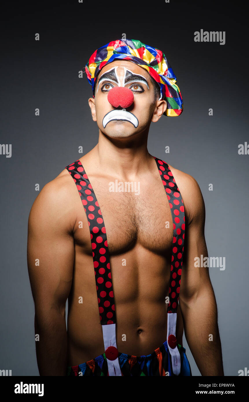 Sad clown against dark background Stock Photo - Alamy