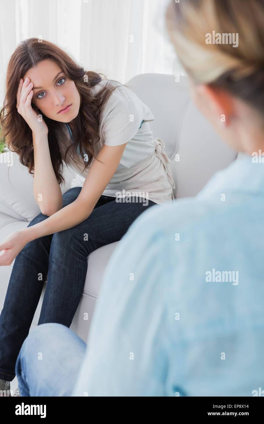 Upset woman sitting and looking at camera during therapy Stock Photo ...