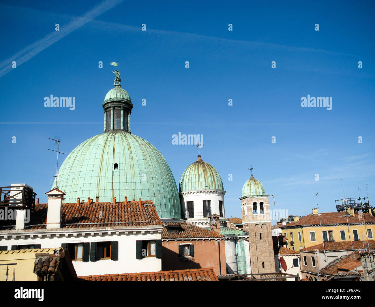 Three cupolas,or domes,in diminishing sizes,against a brilliant blue ...
