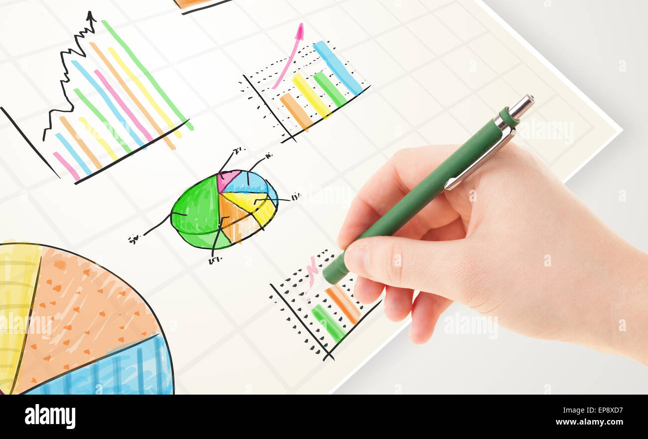 Business person drawing colorful graphs and icons on paper Stock Photo ...