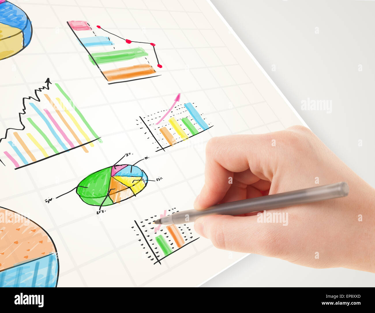 Business person drawing colorful graphs and icons on paper Stock Photo ...