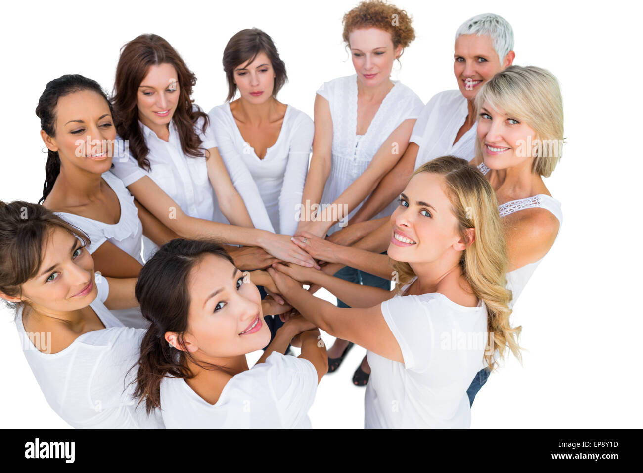 Female models joining hands in a circle and looking at camera Stock ...