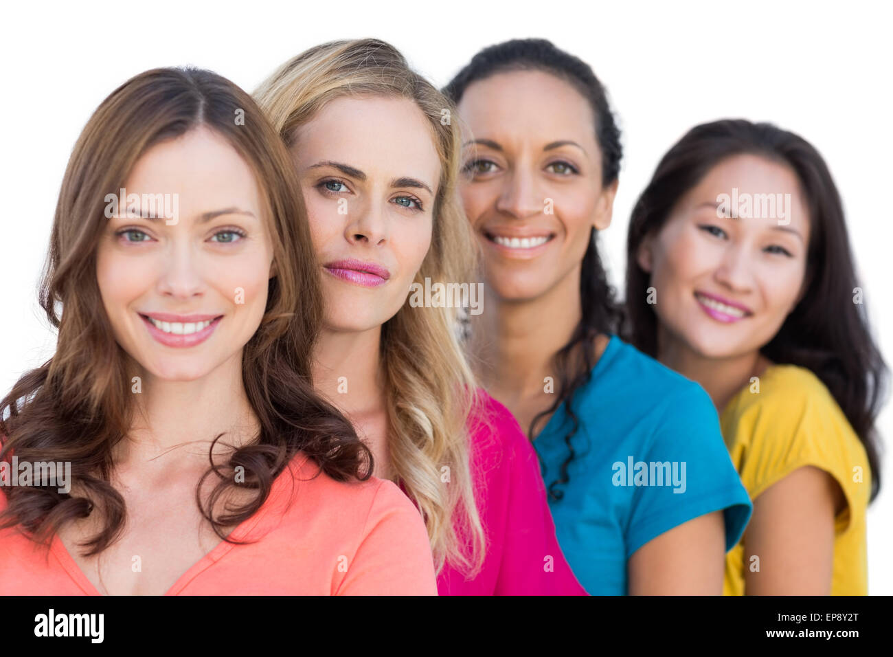 Smiling models in a line posing with colorful t shirts Stock Photo - Alamy