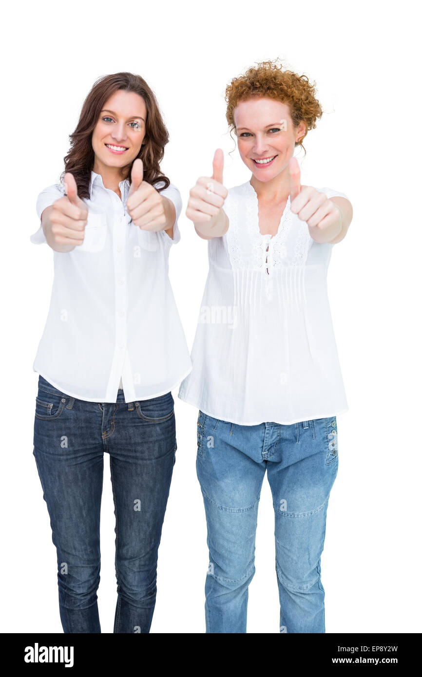 Two gorgeous casual models posing with thumbs up Stock Photo - Alamy