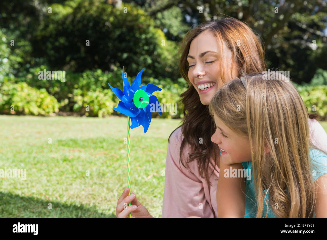 Mother with daughter with a pinwheel in the park Stock Photo - Alamy