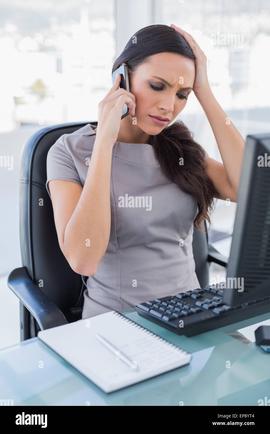 Worried gorgeous businesswoman having a phone call Stock Photo - Alamy
