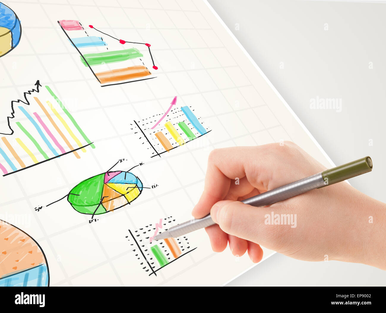 Business person drawing colorful graphs and icons on paper Stock Photo ...