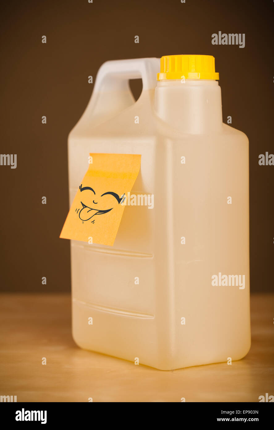Post-it note with smiley face sticked on gallon Stock Photo - Alamy