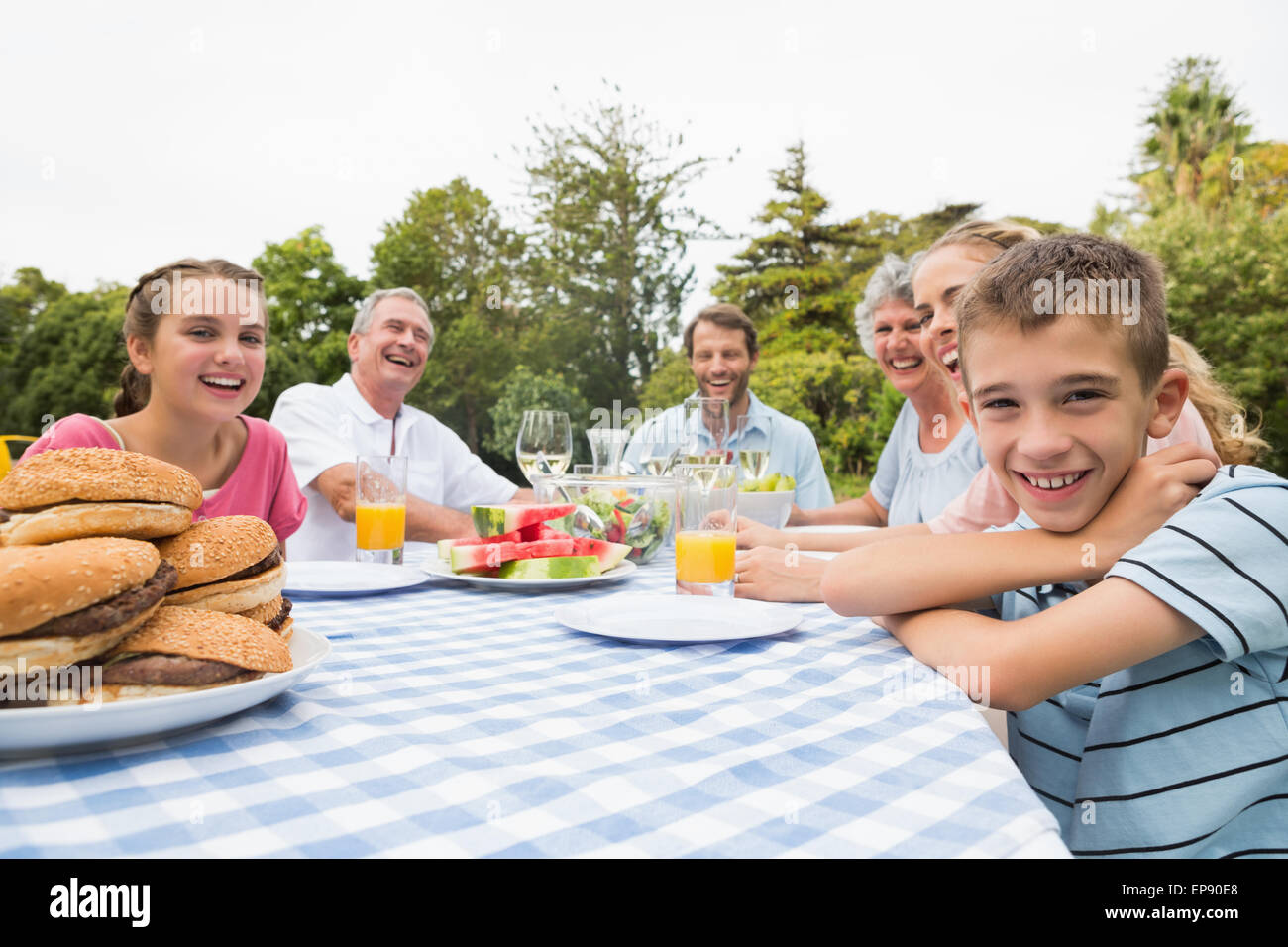 Extended family having dinner outdoors at picnic table Stock Photo - Alamy