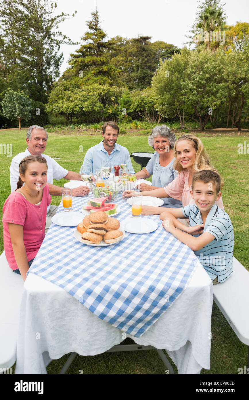 Happy extended family having dinner outdoors at picnic table Stock ...