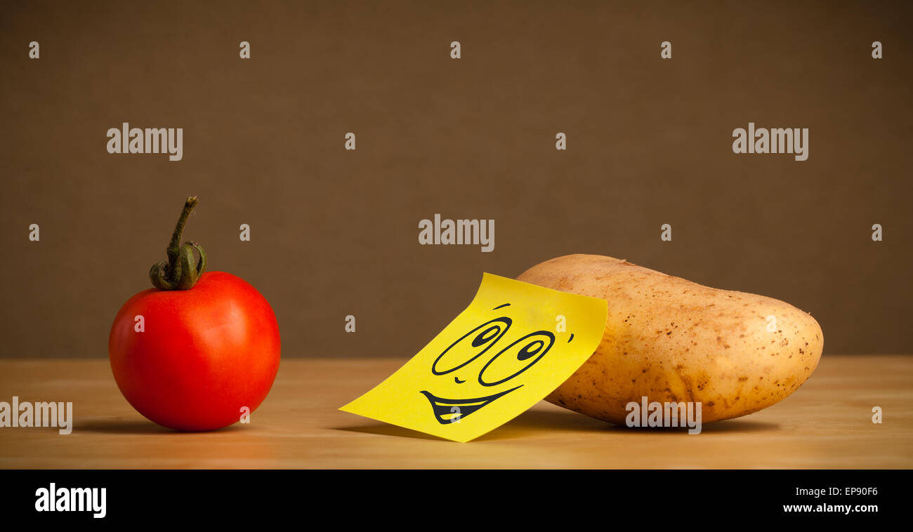 Potato with post-it note looking at tomato Stock Photo - Alamy