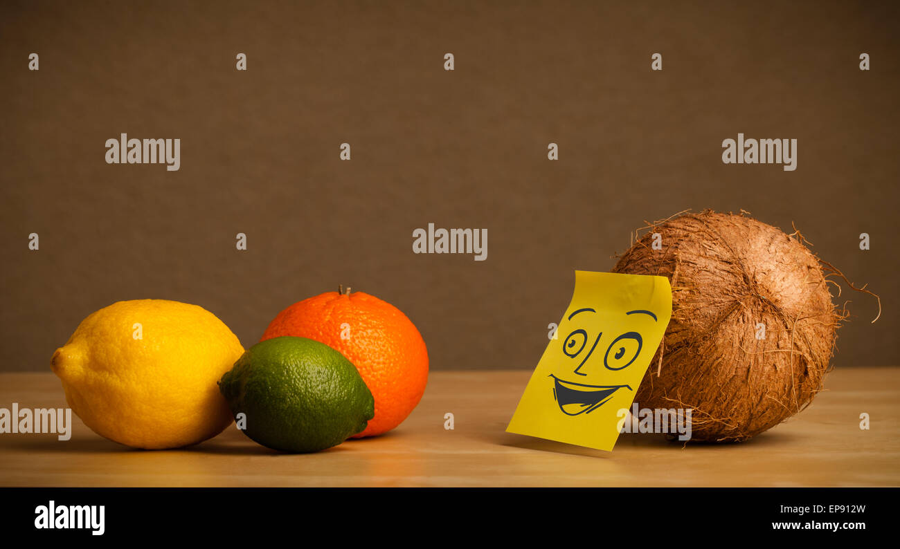 Coconut with post-it note smiling at citrus fruits Stock Photo - Alamy