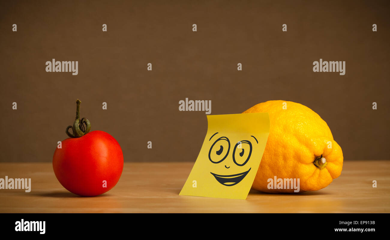 Lemon with post-it note watching at tomato Stock Photo - Alamy