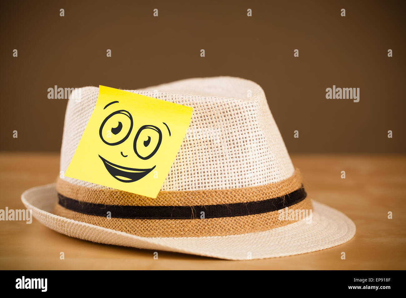 Post-it note with smiley face sticked on hat Stock Photo - Alamy