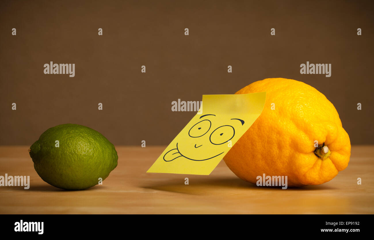 Lemon with post-it note sticking out tongue to lime Stock Photo - Alamy
