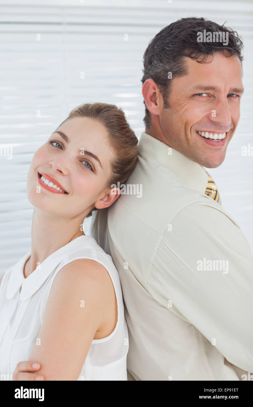 Attractive happy business team posing back to back Stock Photo - Alamy