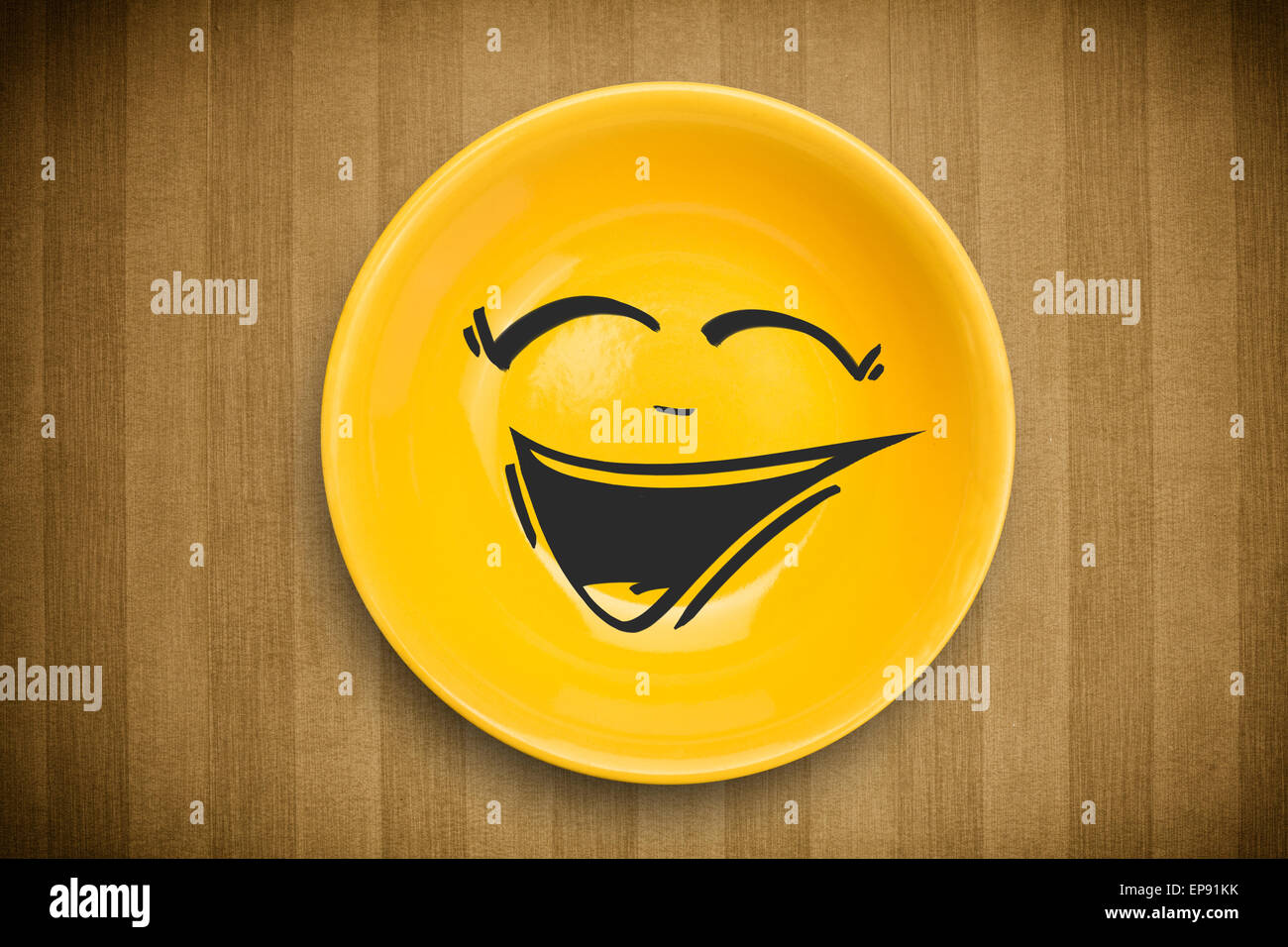 Happy smiley cartoon face on colorful dish plate Stock Photo - Alamy