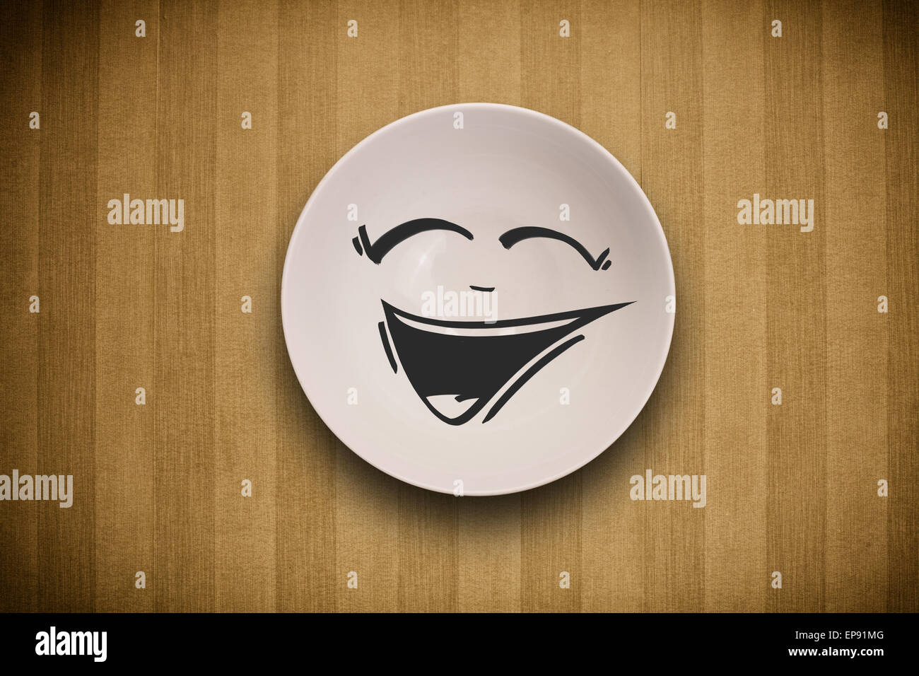 Happy smiley cartoon face on colorful dish plate Stock Photo - Alamy
