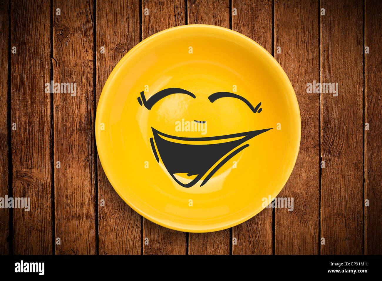 Happy smiley cartoon face on colorful dish plate Stock Photo - Alamy