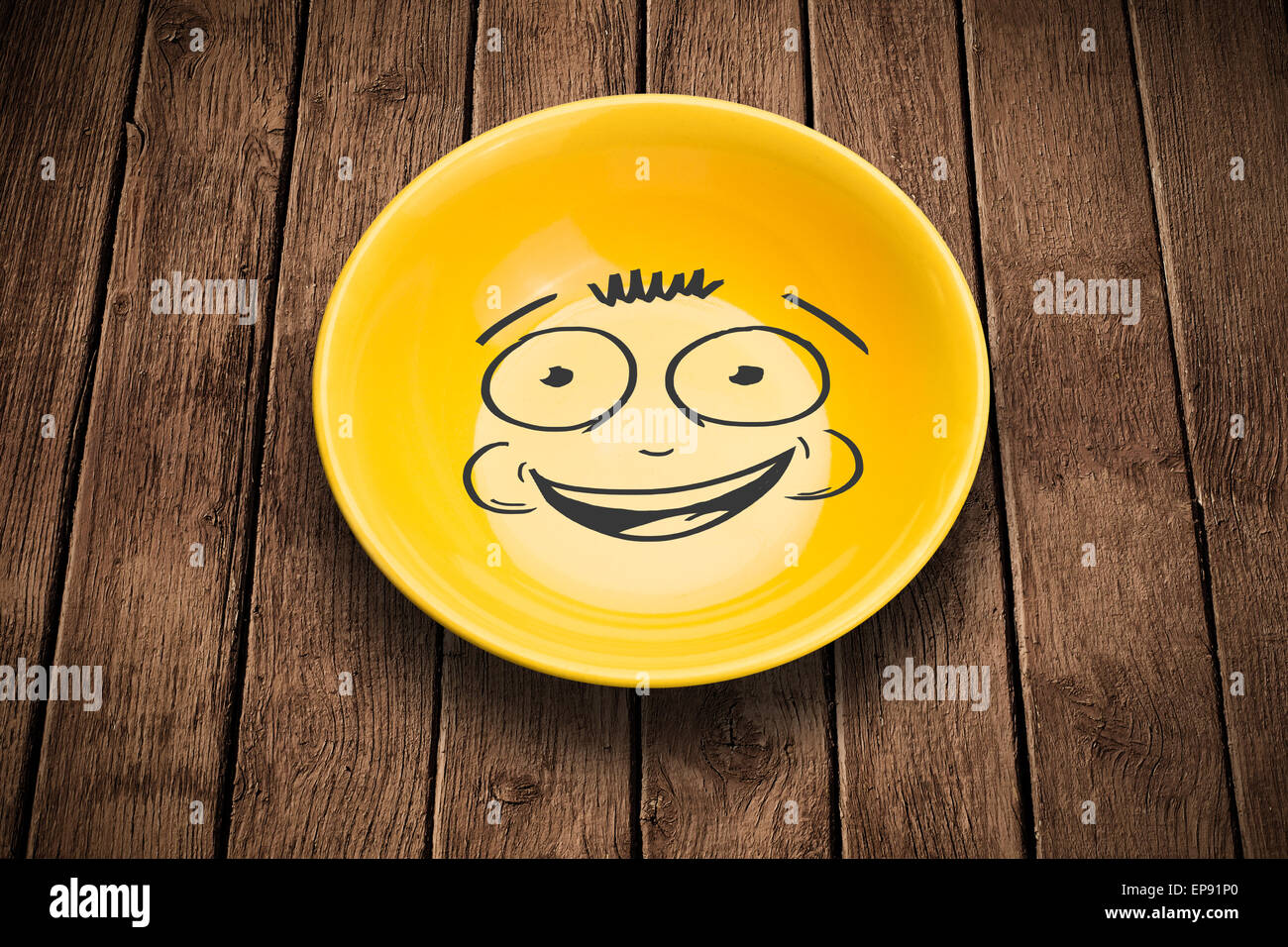 Happy smiley cartoon face on colorful dish plate Stock Photo - Alamy