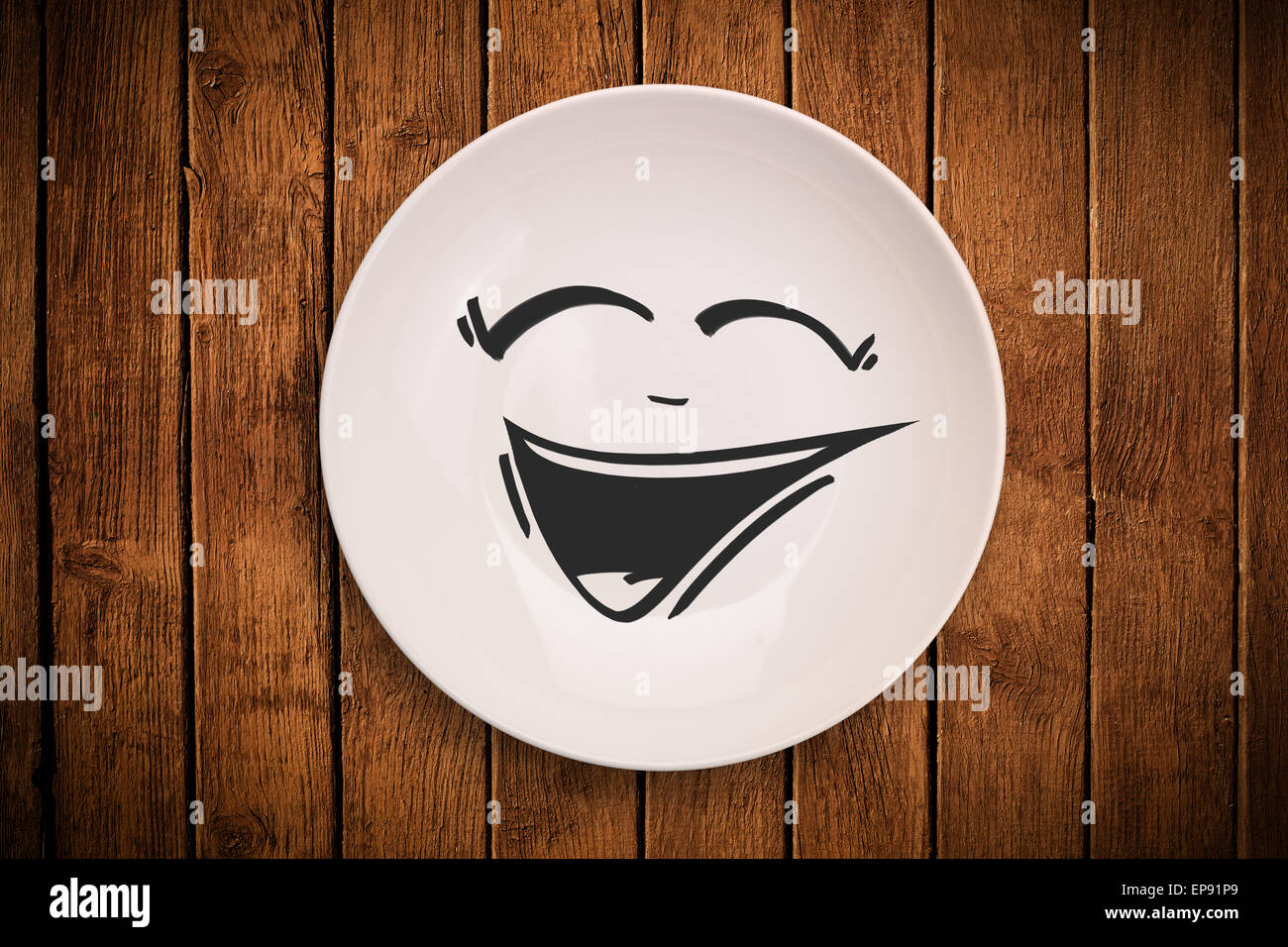 Happy smiley cartoon face on colorful dish plate Stock Photo - Alamy