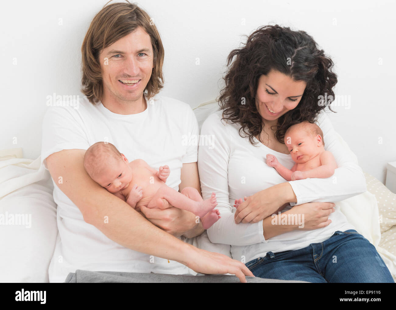 Parents with twin baby´s Stock Photo - Alamy