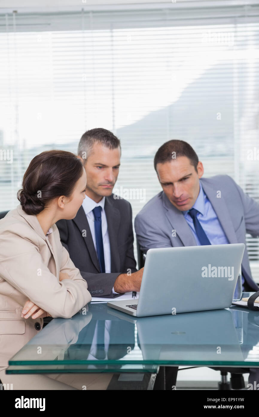 Serious colleagues working together on their laptop Stock Photo - Alamy