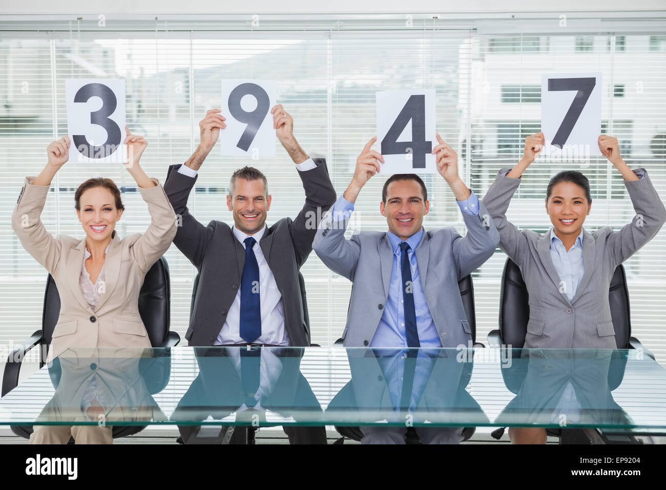 Smiling interview panel holding signs giving grade to their applicant ...