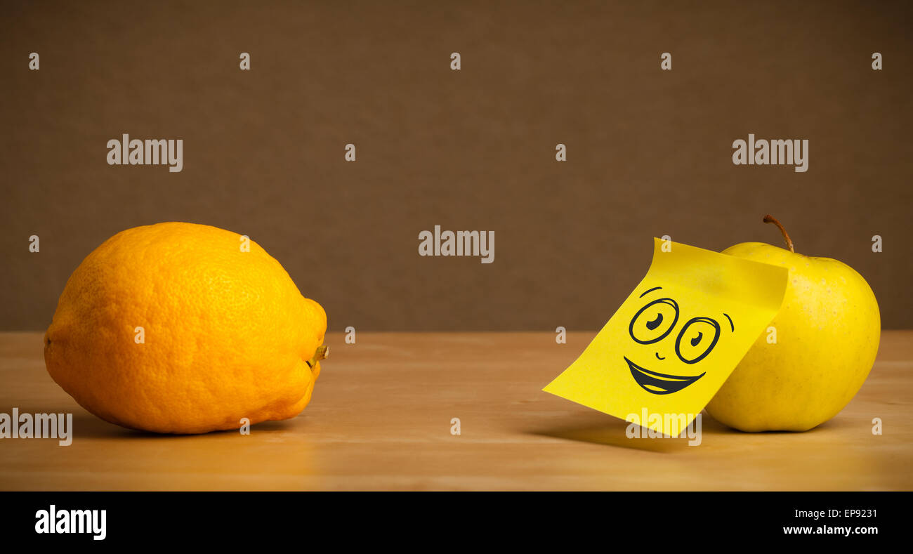 Apple with post-it note watching at lemon Stock Photo - Alamy