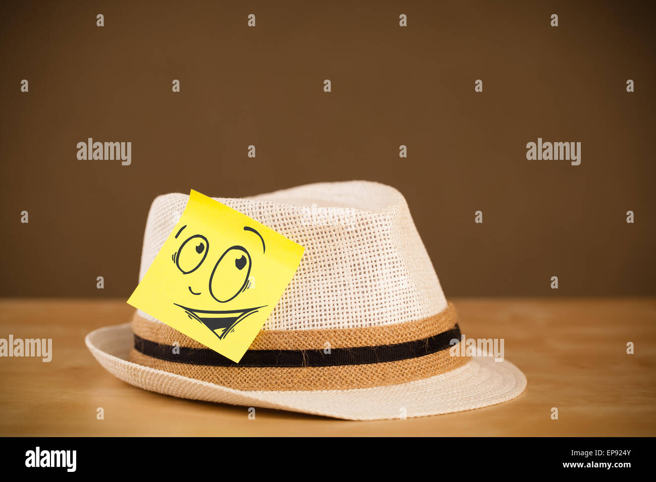 Post-it note with smiley face sticked on hat Stock Photo - Alamy