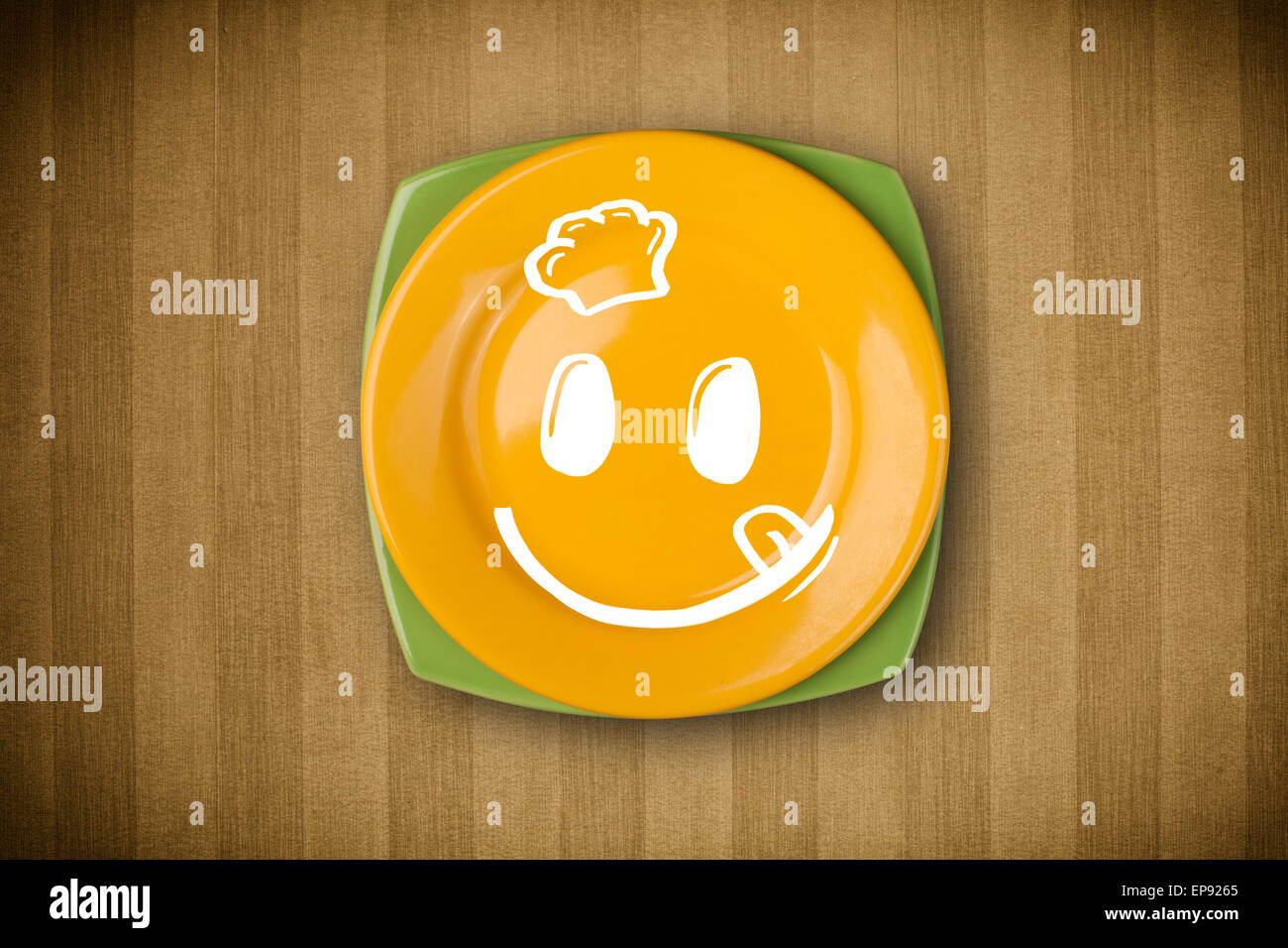 Happy smiley cartoon face on colorful dish plate Stock Photo - Alamy