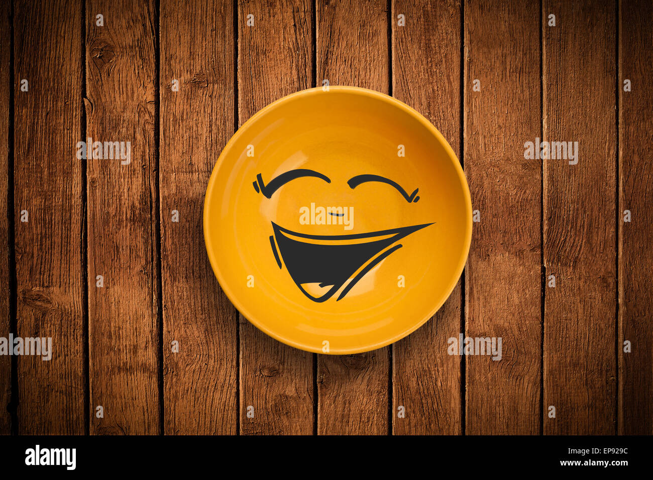 Happy smiley cartoon face on colorful dish plate Stock Photo - Alamy