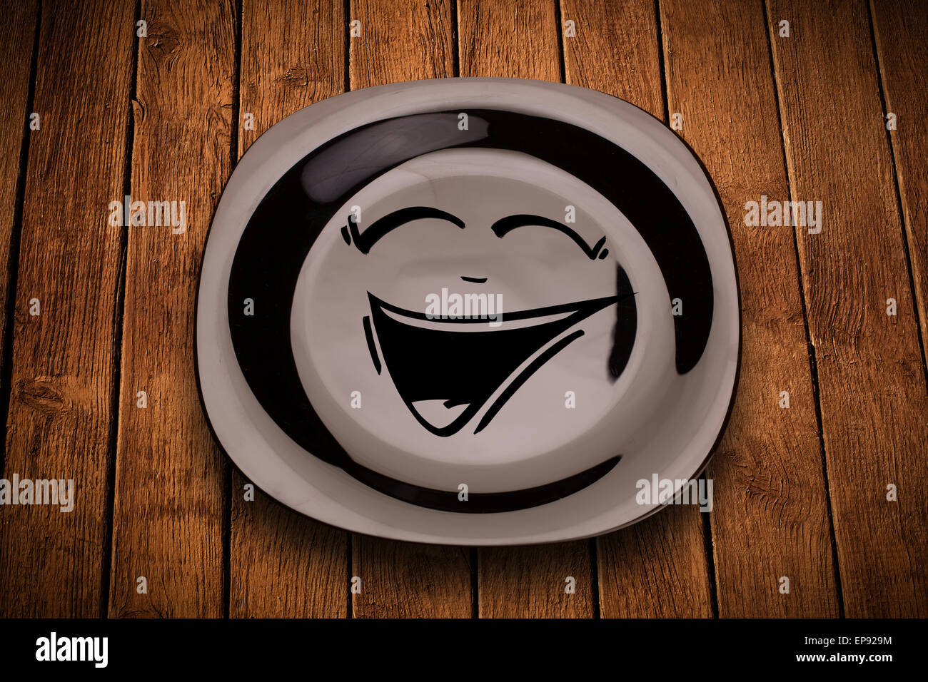 Happy smiley cartoon face on colorful dish plate Stock Photo - Alamy