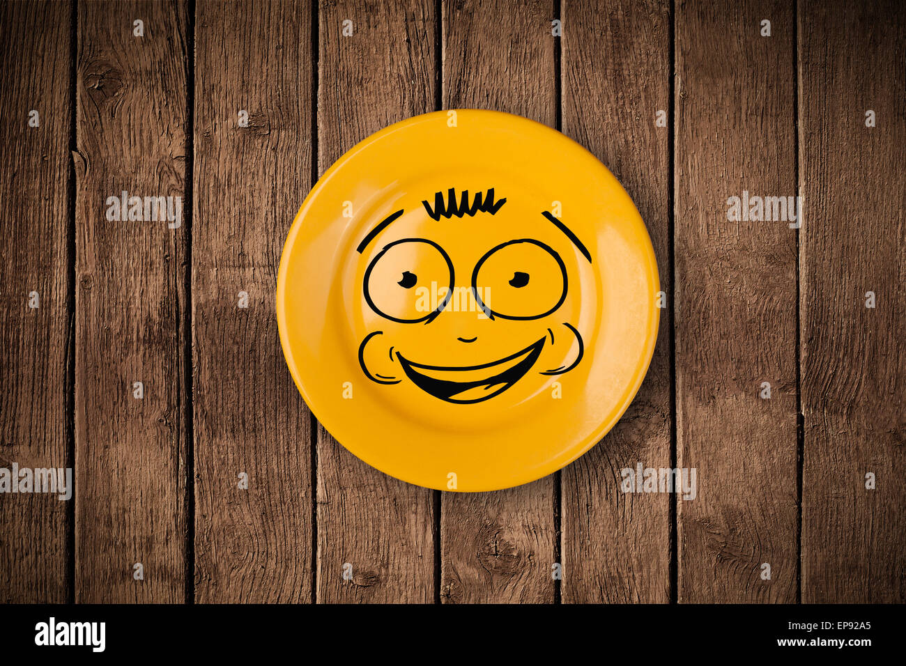 Happy smiley cartoon face on colorful dish plate Stock Photo - Alamy