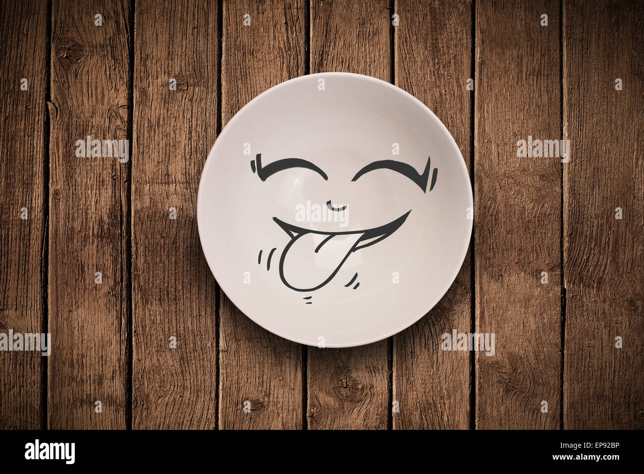 Happy smiley cartoon face on colorful dish plate Stock Photo - Alamy