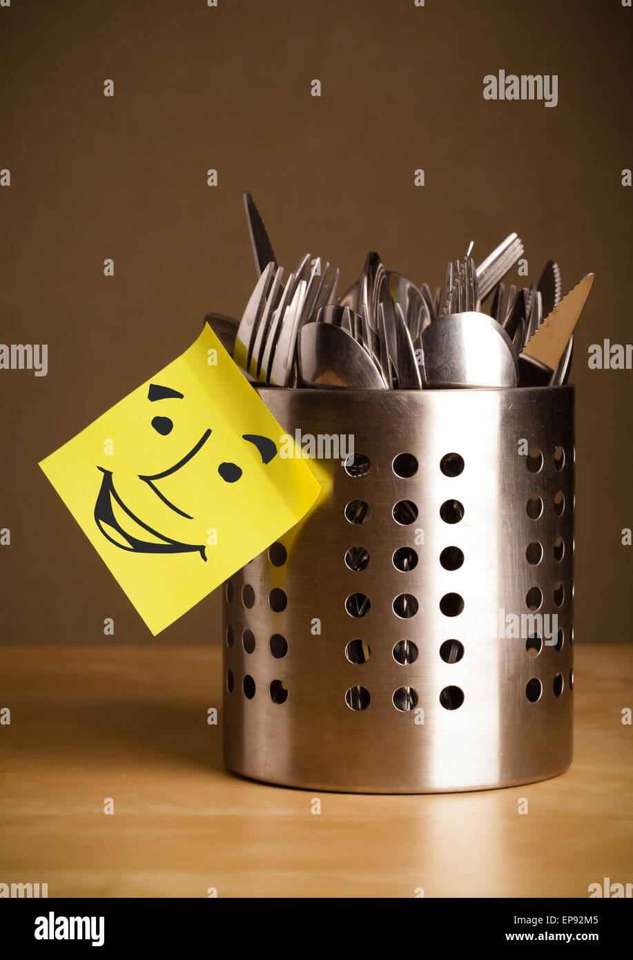 Post-it note with smiley face sticked on a cutlery case Stock Photo - Alamy
