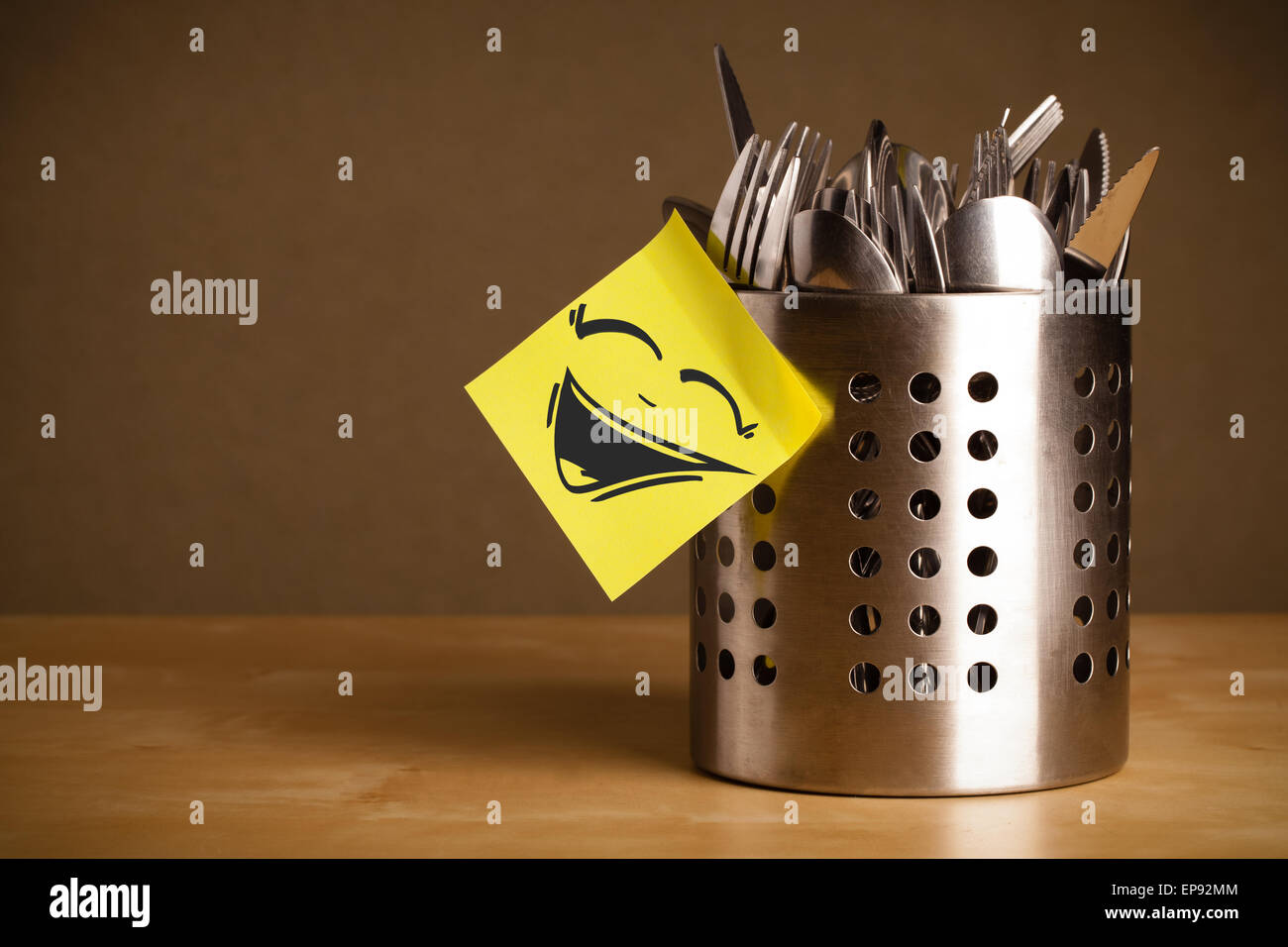 Post-it note with smiley face sticked on cutlery case Stock Photo - Alamy