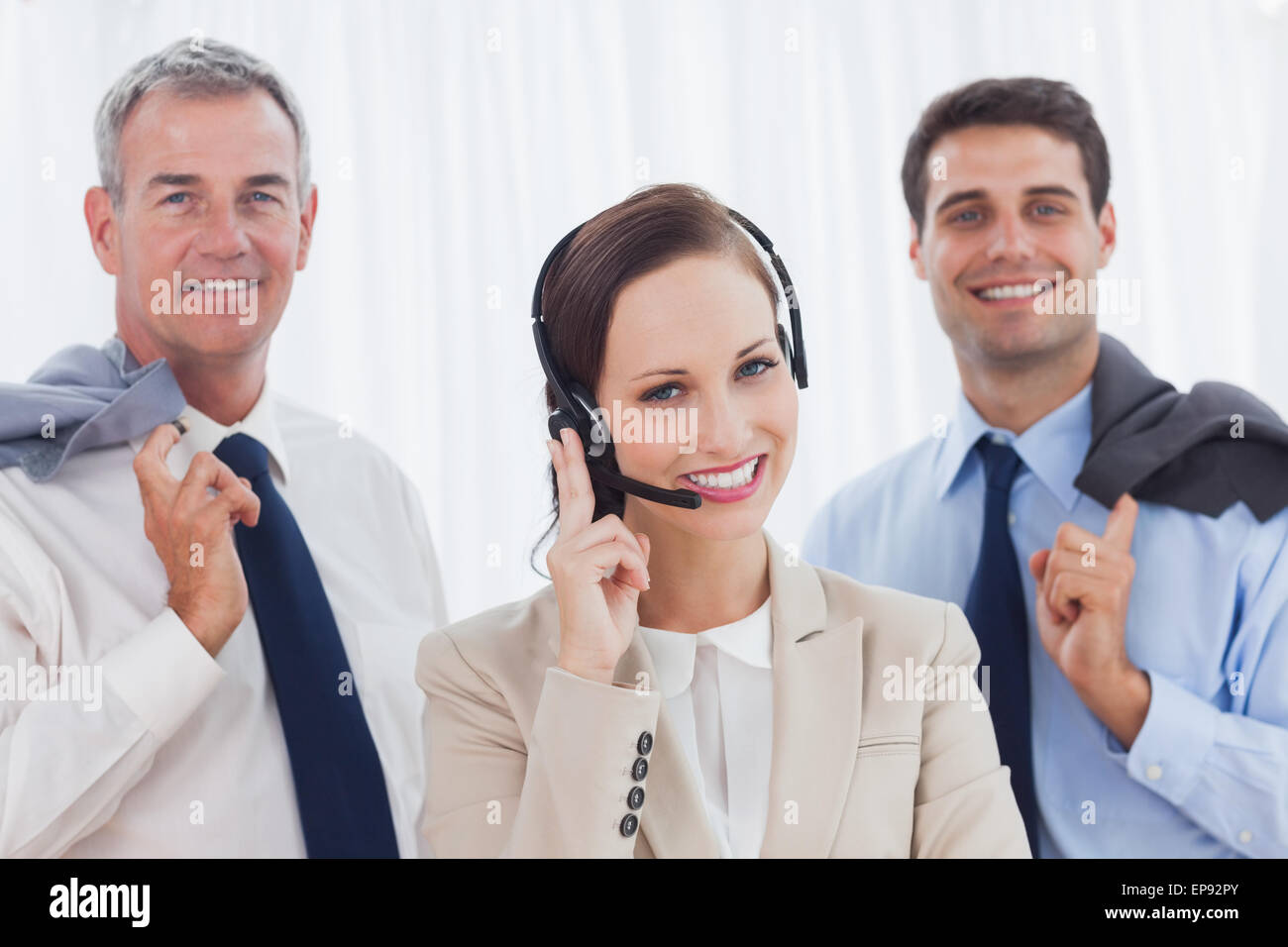 Smiling call center agent posing with her work team Stock Photo - Alamy