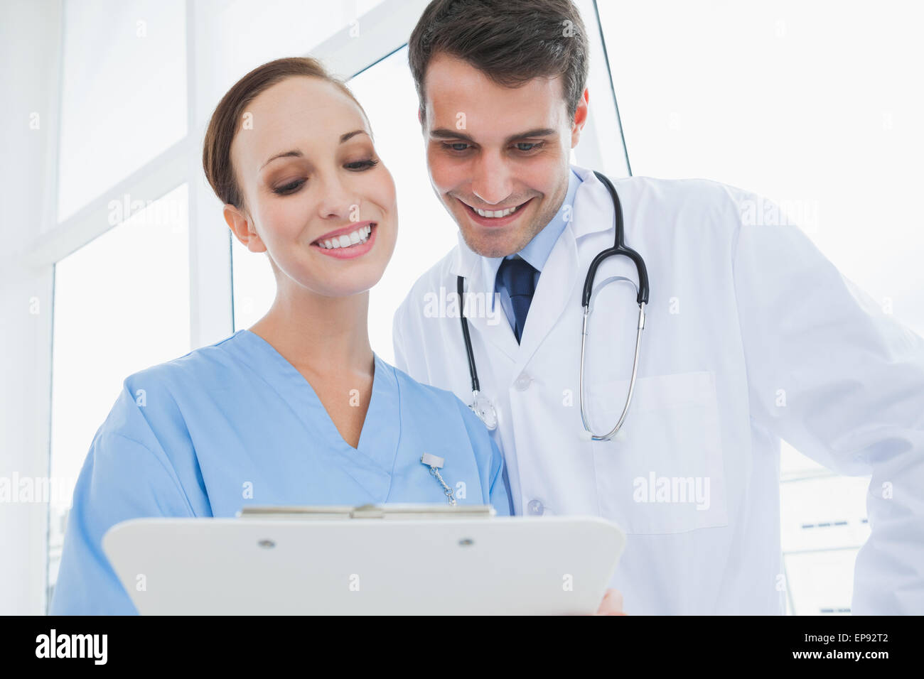 Cheerful doctor and surgeon viewing documents together Stock Photo - Alamy
