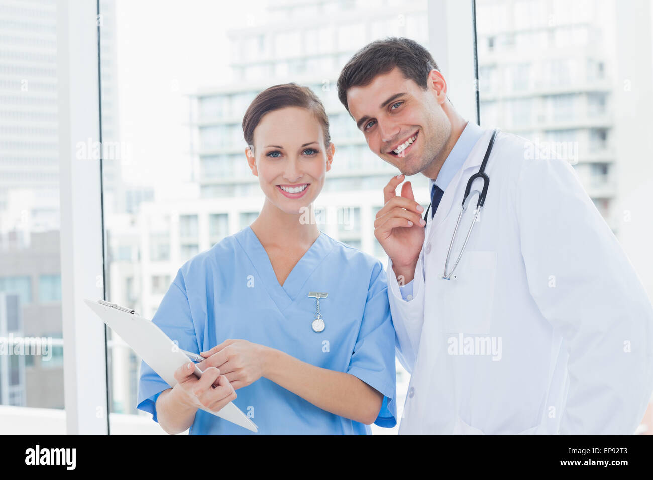 Cheerful surgeon and doctor posing while working together Stock Photo ...