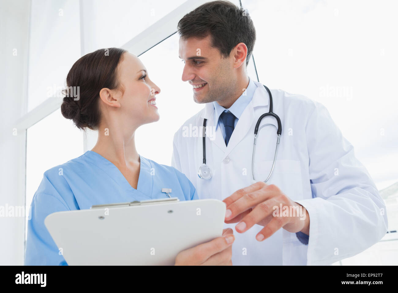 Cheerful doctor and surgeon looking at each other Stock Photo - Alamy