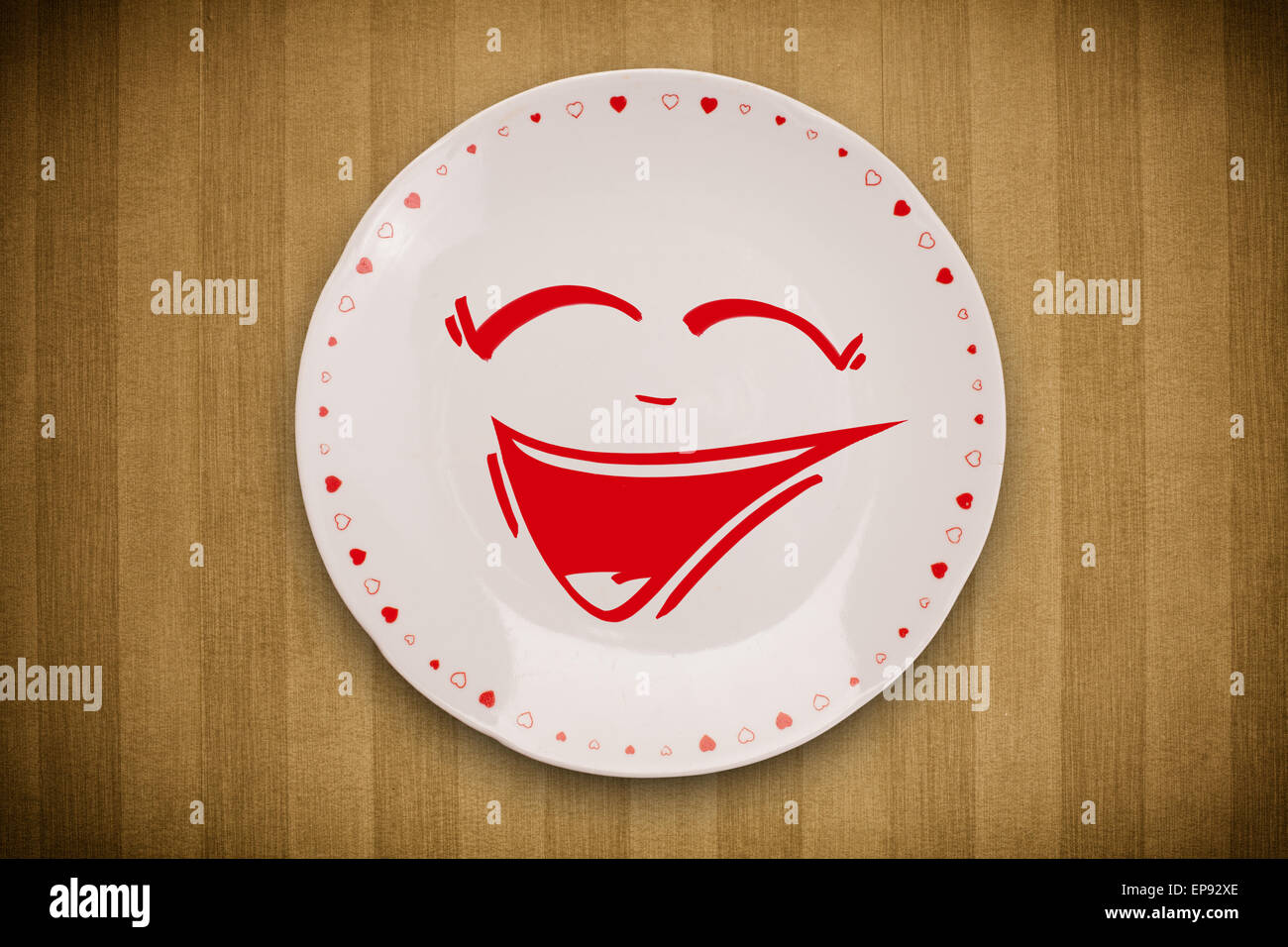 Happy smiley cartoon face on colorful dish plate Stock Photo - Alamy