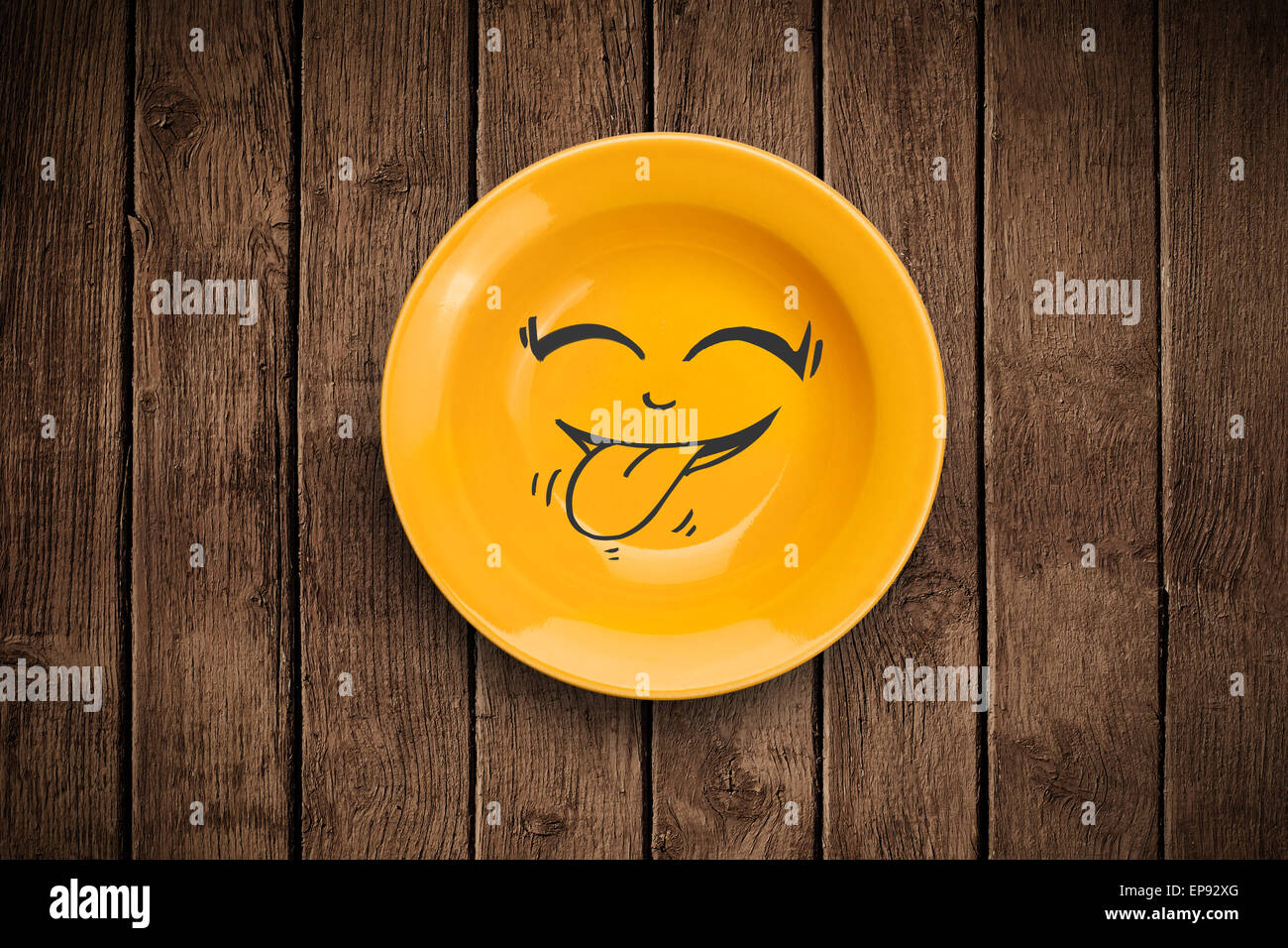 Happy smiley cartoon face on colorful dish plate Stock Photo - Alamy