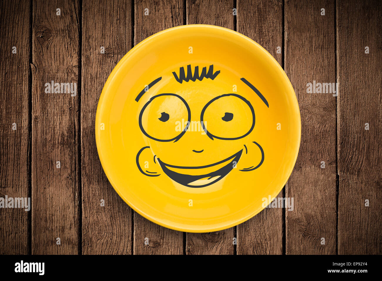 Happy smiley cartoon face on colorful dish plate Stock Photo - Alamy