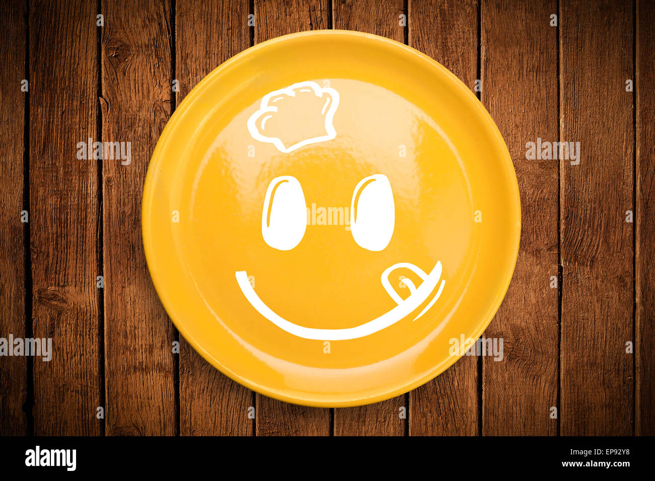 Happy smiley cartoon face on colorful dish plate Stock Photo - Alamy