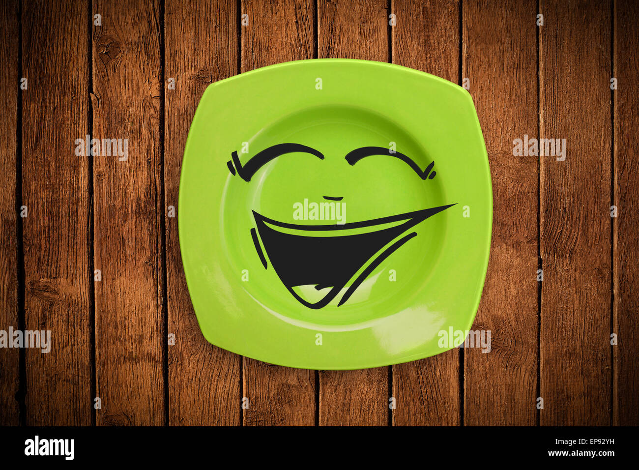 Happy smiley cartoon face on colorful dish plate Stock Photo - Alamy